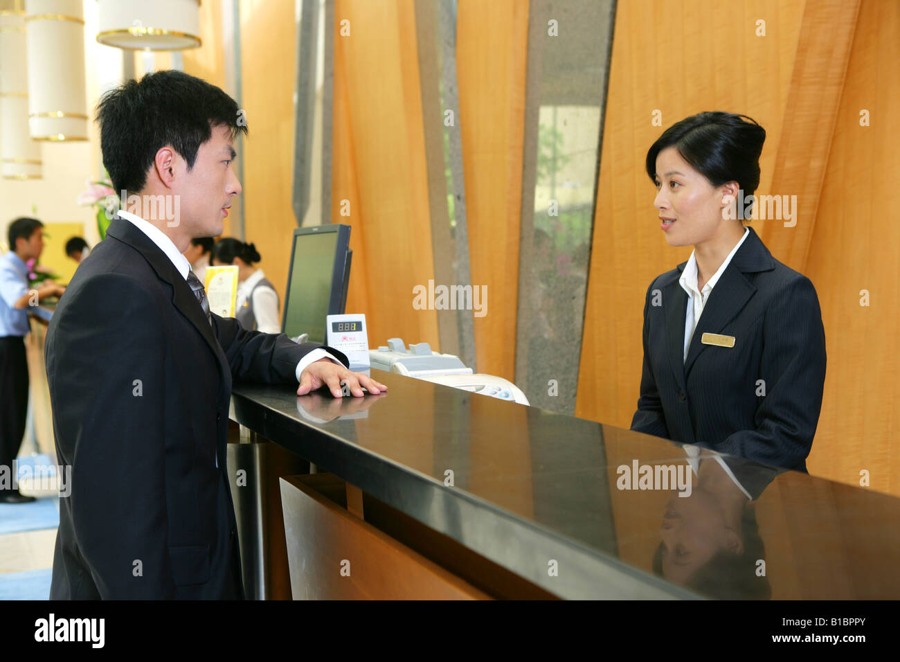 businessman at hotel reception Stock Photo - Alamy