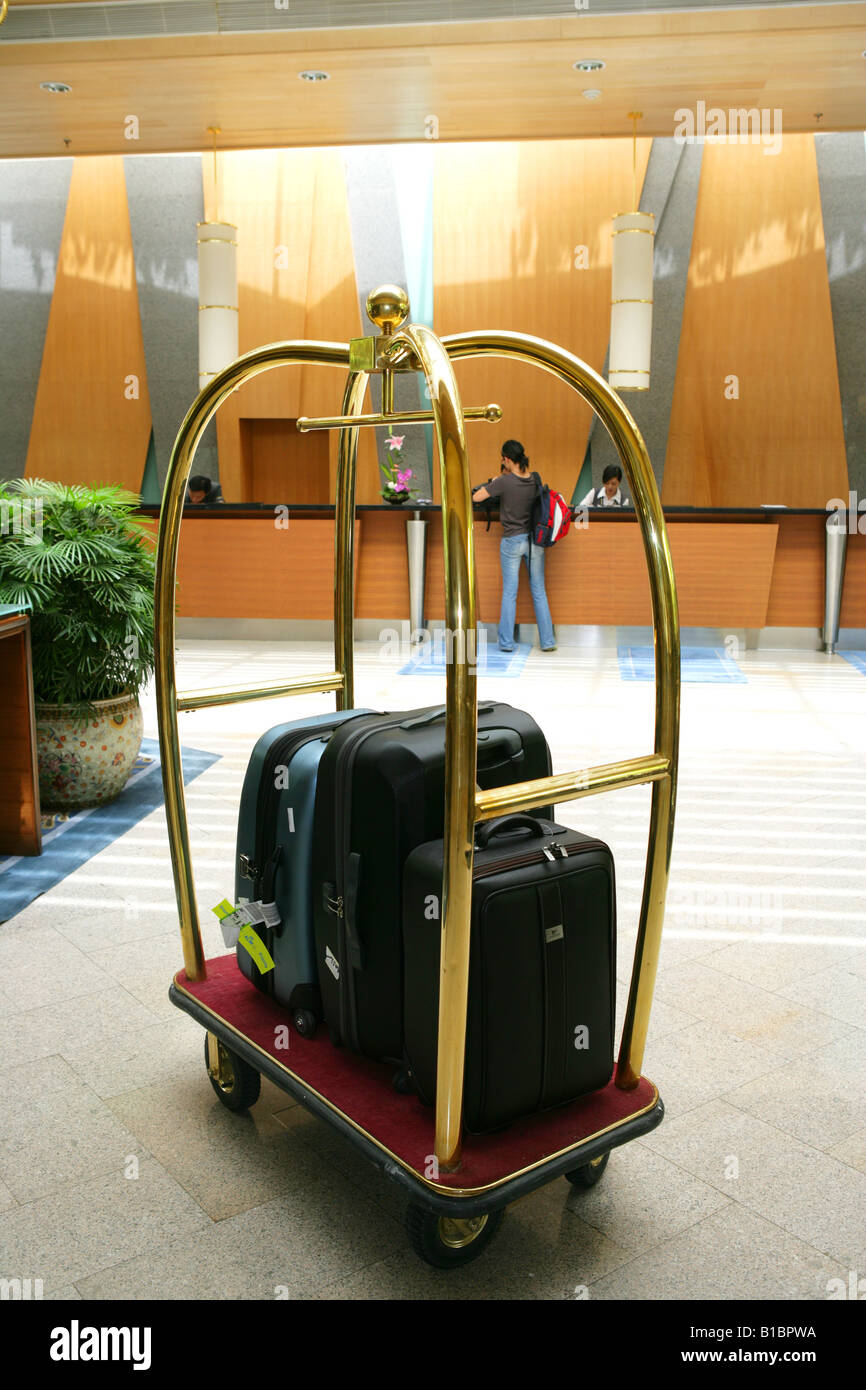 luggage cart,hotel reception in background Stock Photo - Alamy