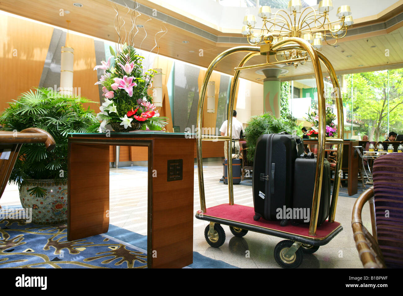 luggage cart,hotel reception in background Stock Photo - Alamy