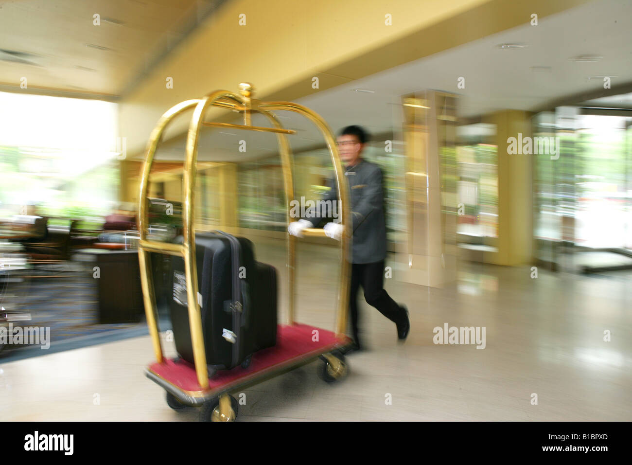 Bellhop with luggage cart hi-res stock photography and images - Alamy