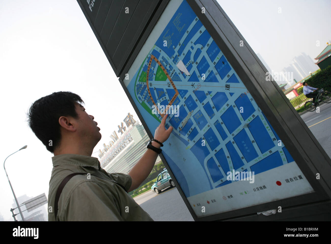 male tourist looking at map at Pudong,Shanghai,China Stock Photo - Alamy
