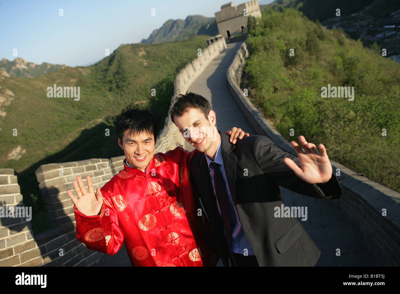 Chinese traditional man and caucasian businessman standing on Great ...