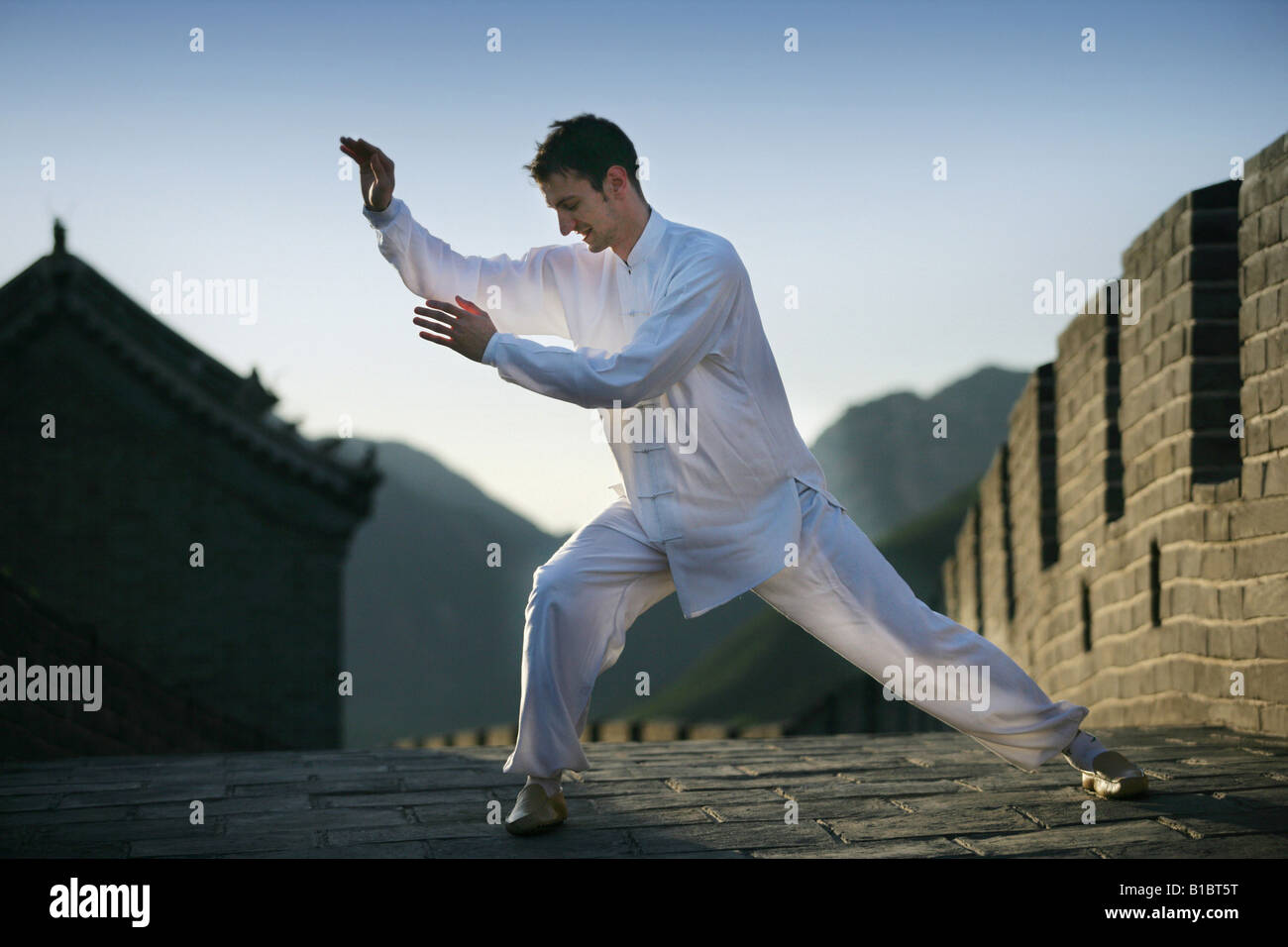 caucasian in Chinese traditional clothing practising martial arts on ...