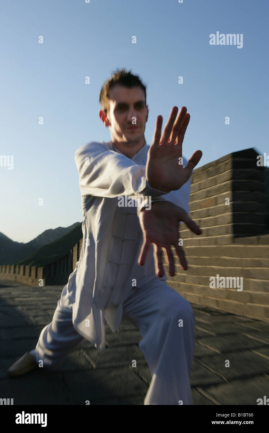 caucasian in Chinese traditional clothing practising martial arts on ...