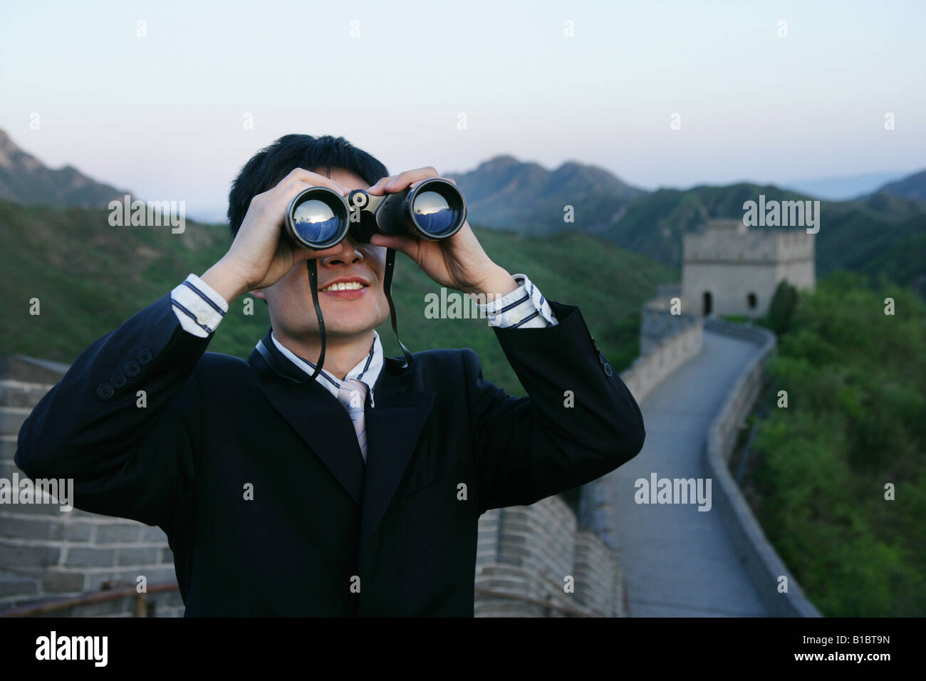businessman watching with telescope on Great Wall,Beijing,China Stock ...