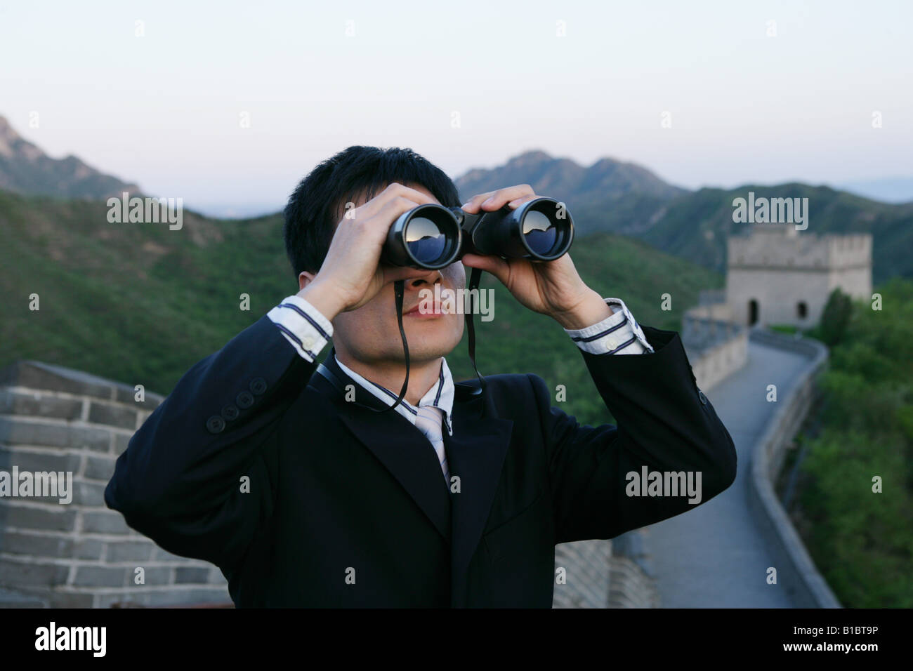 businessman watching with telescope on Great Wall,Beijing,China Stock ...