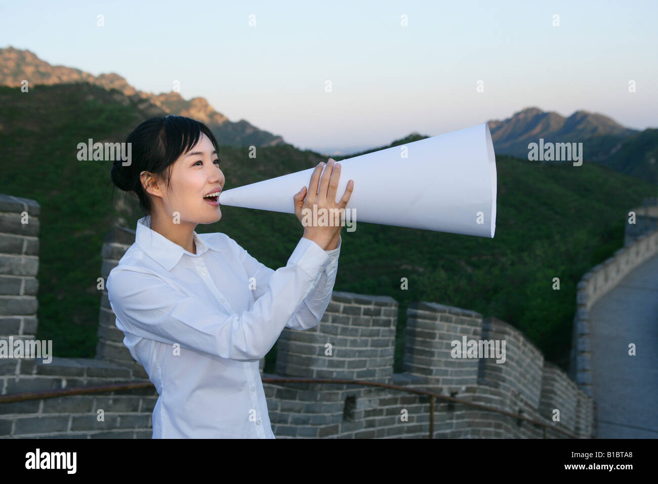 businesswoman shouting into metaphone on Great Wall,Beijing,China Stock ...
