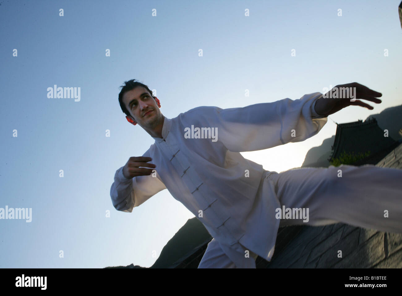 caucasian in Chinese traditional clothing practising martial arts on ...