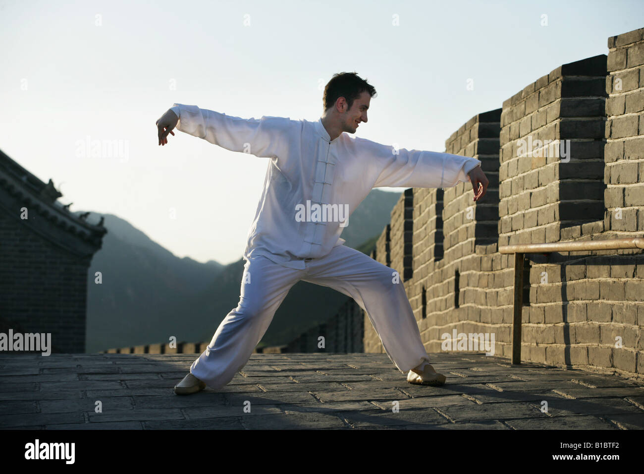caucasian in Chinese traditional clothing practising martial arts on ...