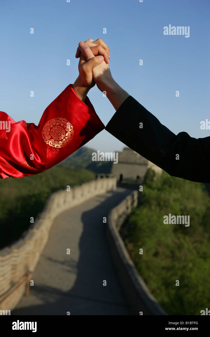 Chinese traditional man and caucasian businessman handshaking on Great ...