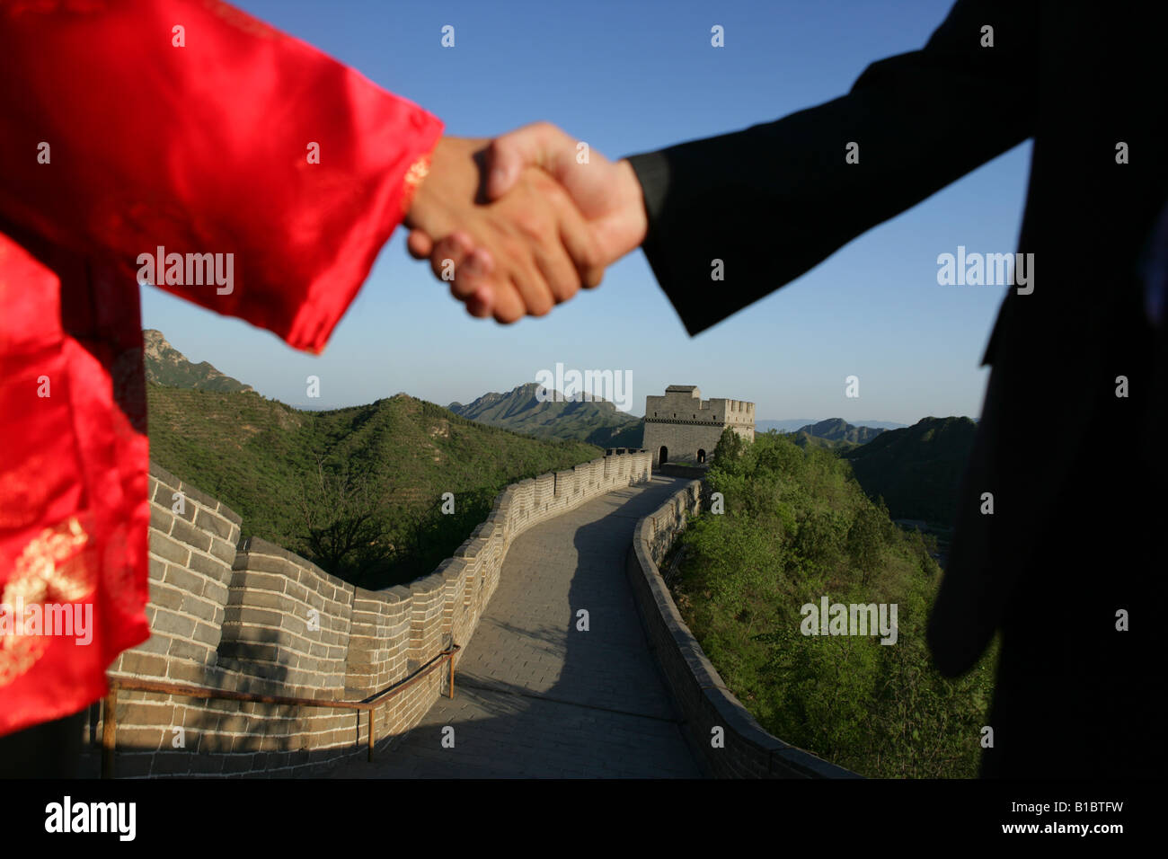 Chinese traditional man and caucasian businessman handshaking on Great ...