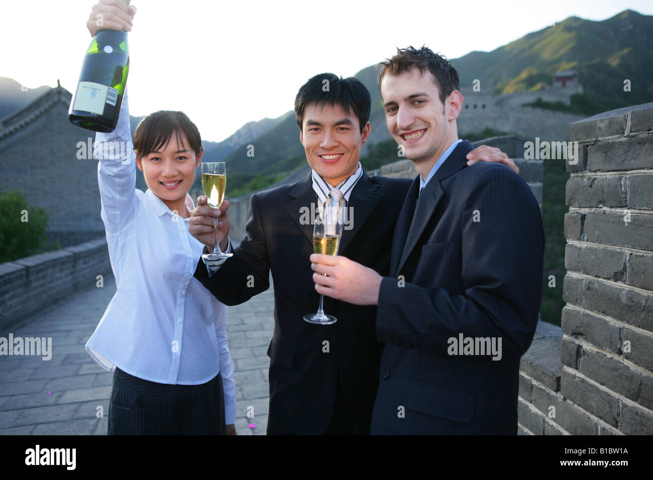 three businessmen and one businesswoman toasting on Great Wall,Beijing ...