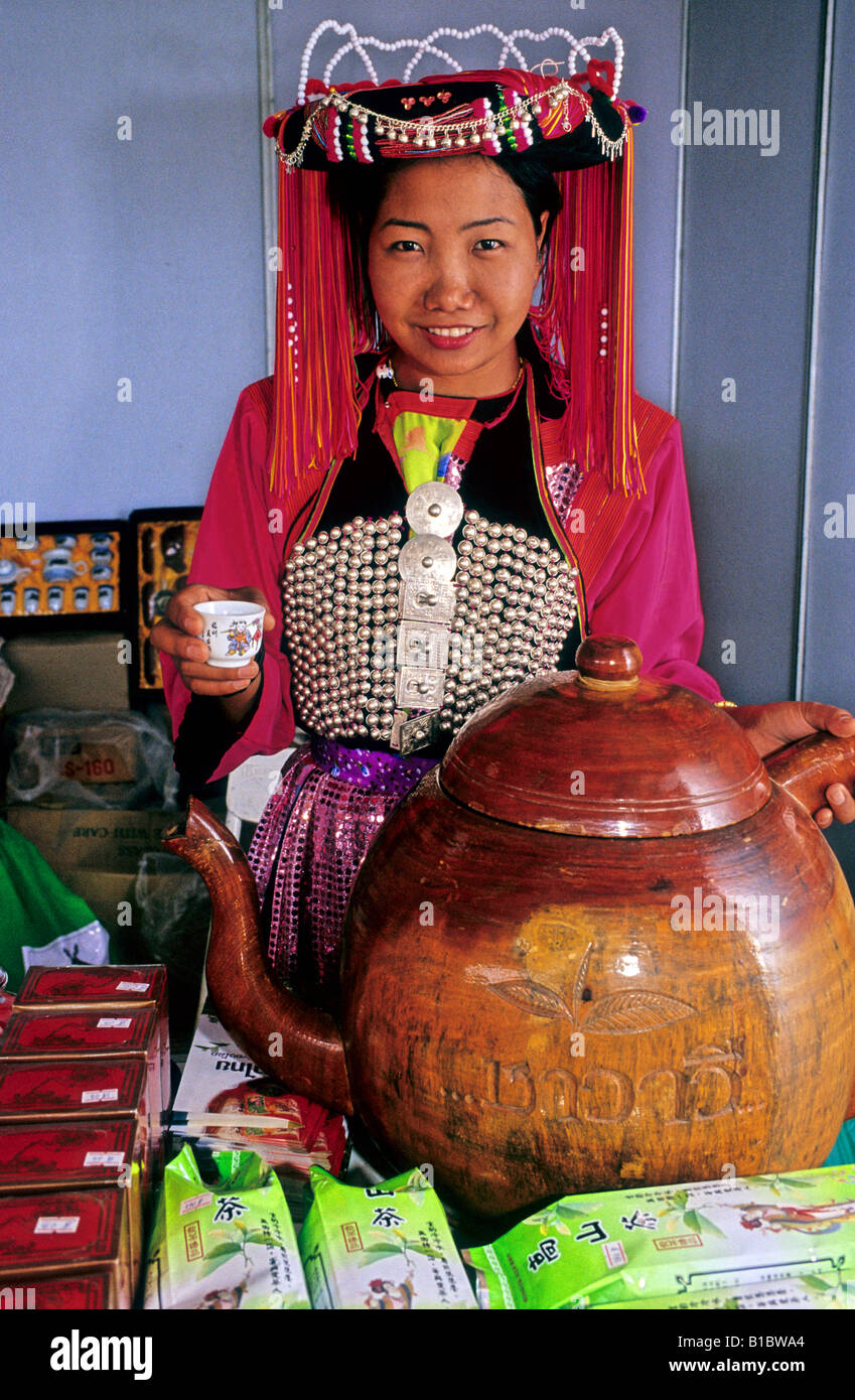 Lisu girl serving tea from giant pot Stock Photo - Alamy