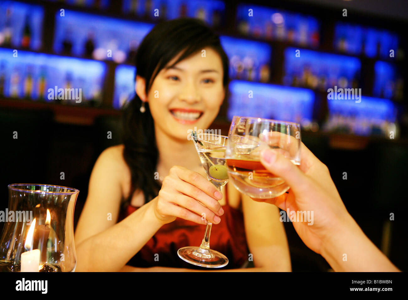 young woman toasting in bar of hotel Stock Photo - Alamy