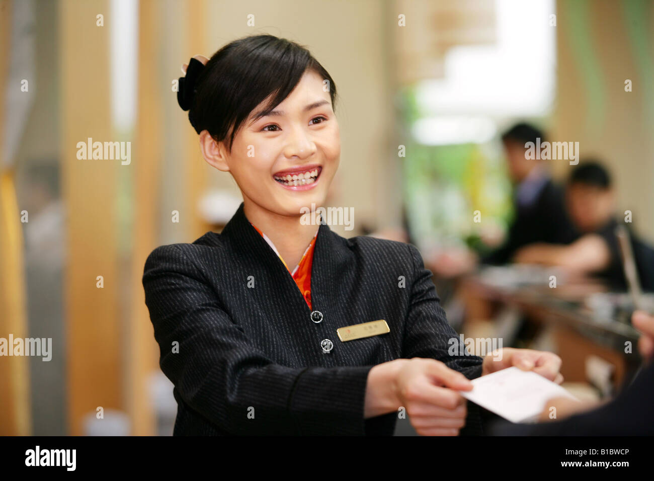 receptionist passing business card Stock Photo - Alamy