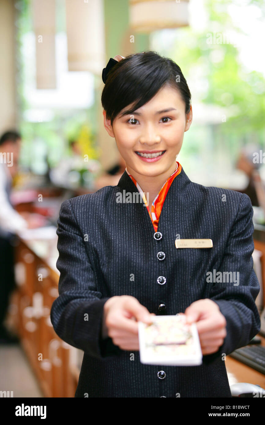 receptionist passing business card Stock Photo - Alamy