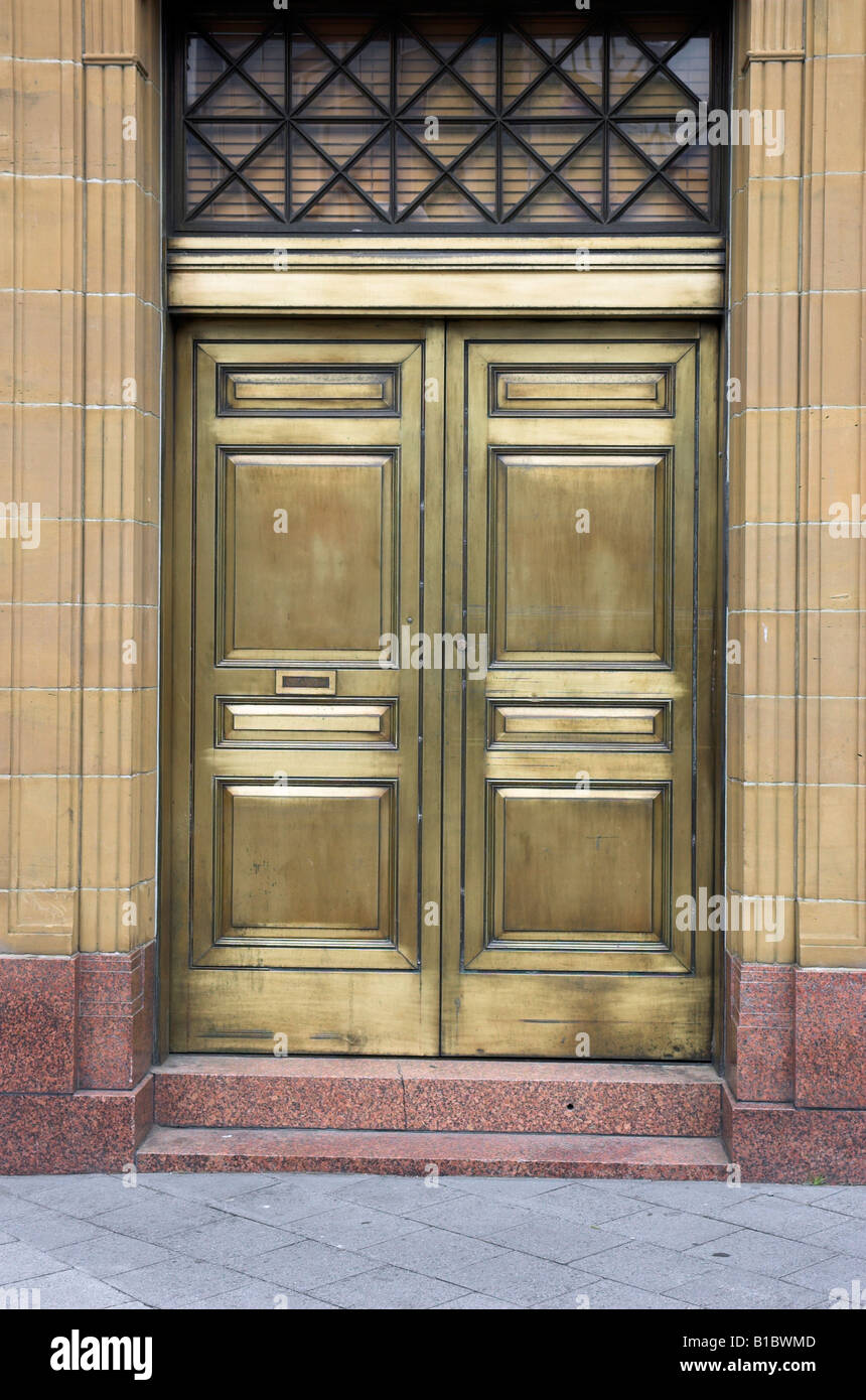 Large and solid golden doors in the entrance to a commercial building ...