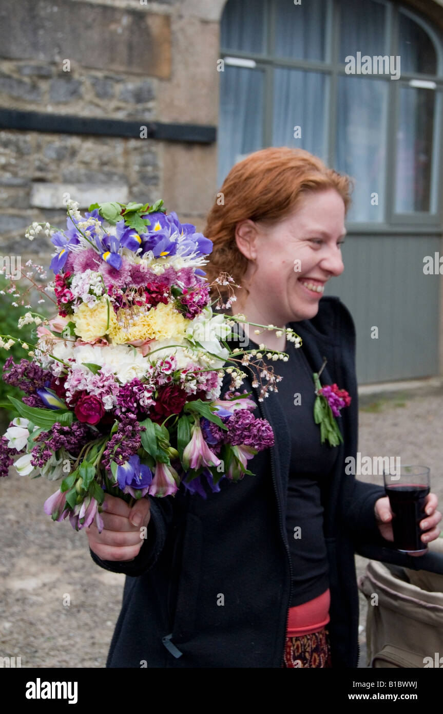 Red haired woman holding bouquet of flowers Garlanding Festival in ...