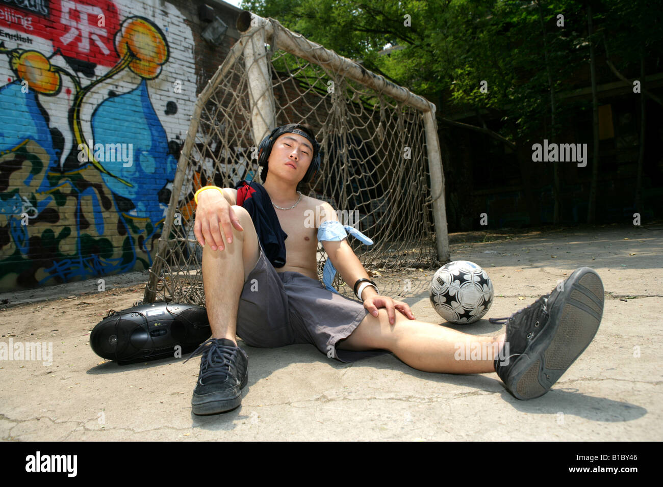 young man resting by goal,portrait Stock Photo - Alamy
