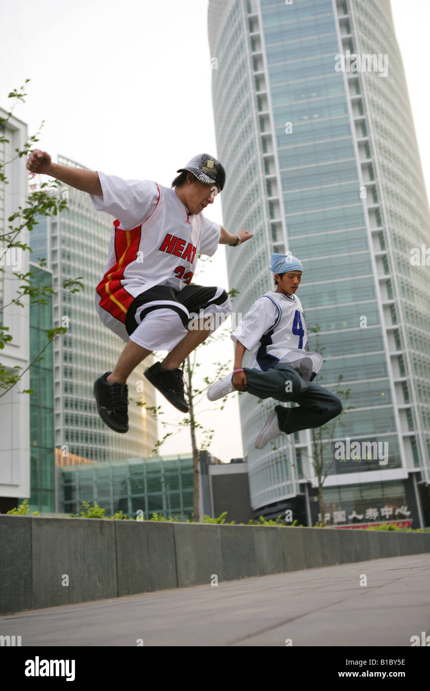 young men jumping on square beside office buildings,Beijing,China Stock ...