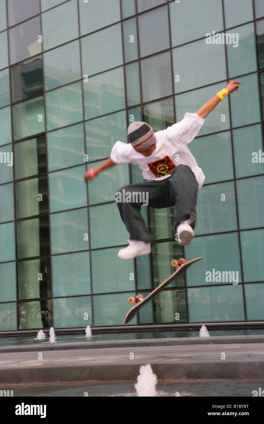 young man skateboarding on square beside office buildings,Beijing,China ...