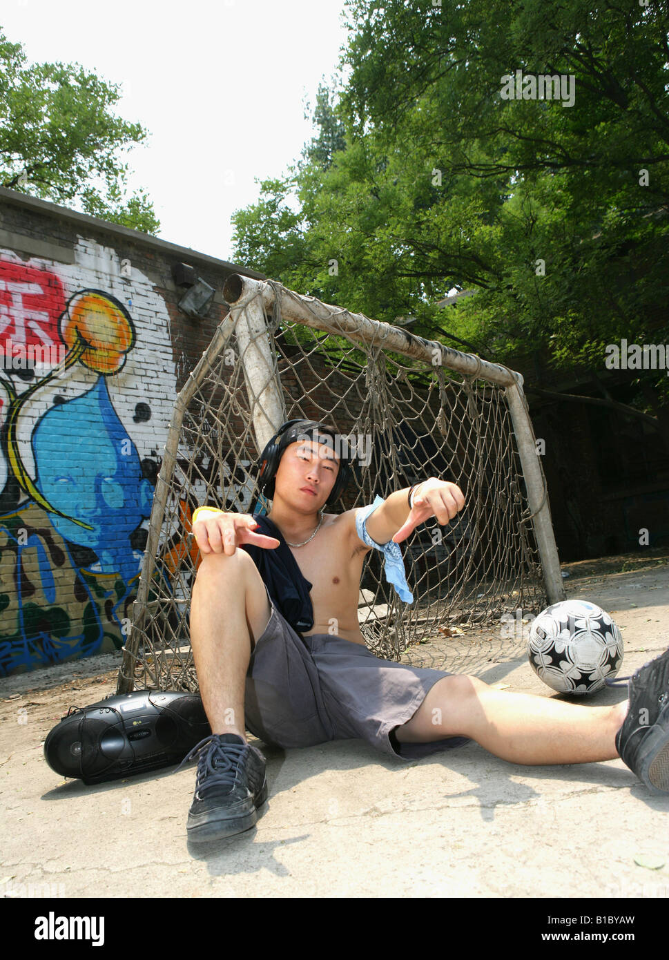 young man resting by goal,portrait Stock Photo - Alamy