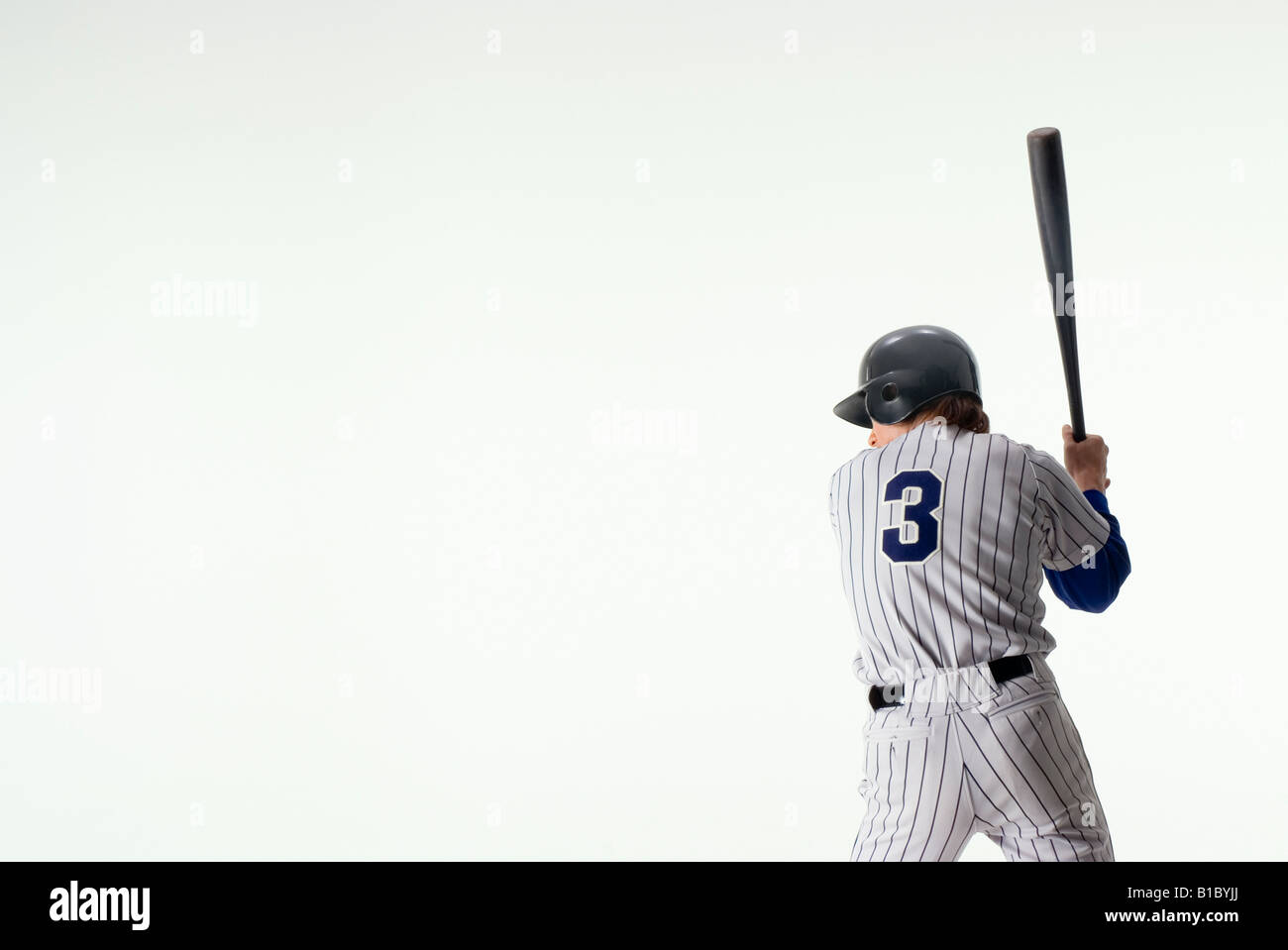 Baseball player standing with bat Stock Photo - Alamy