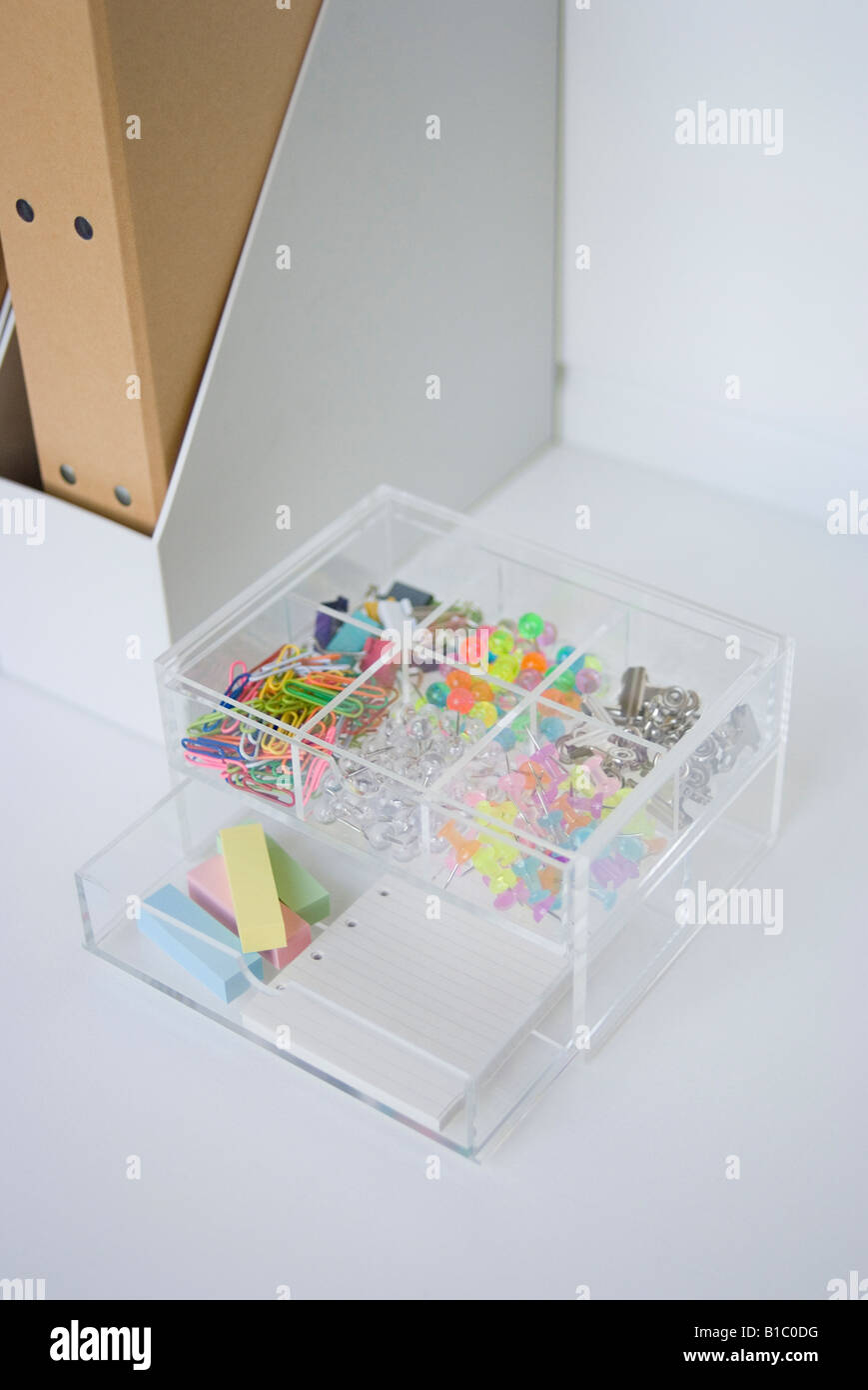 Clips and pushpins in plastic box Stock Photo - Alamy