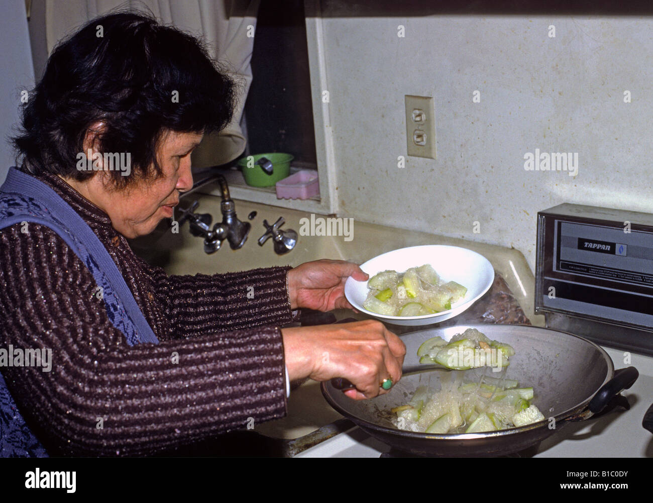 Woman cooks in kitchen hi-res stock photography and images - Alamy