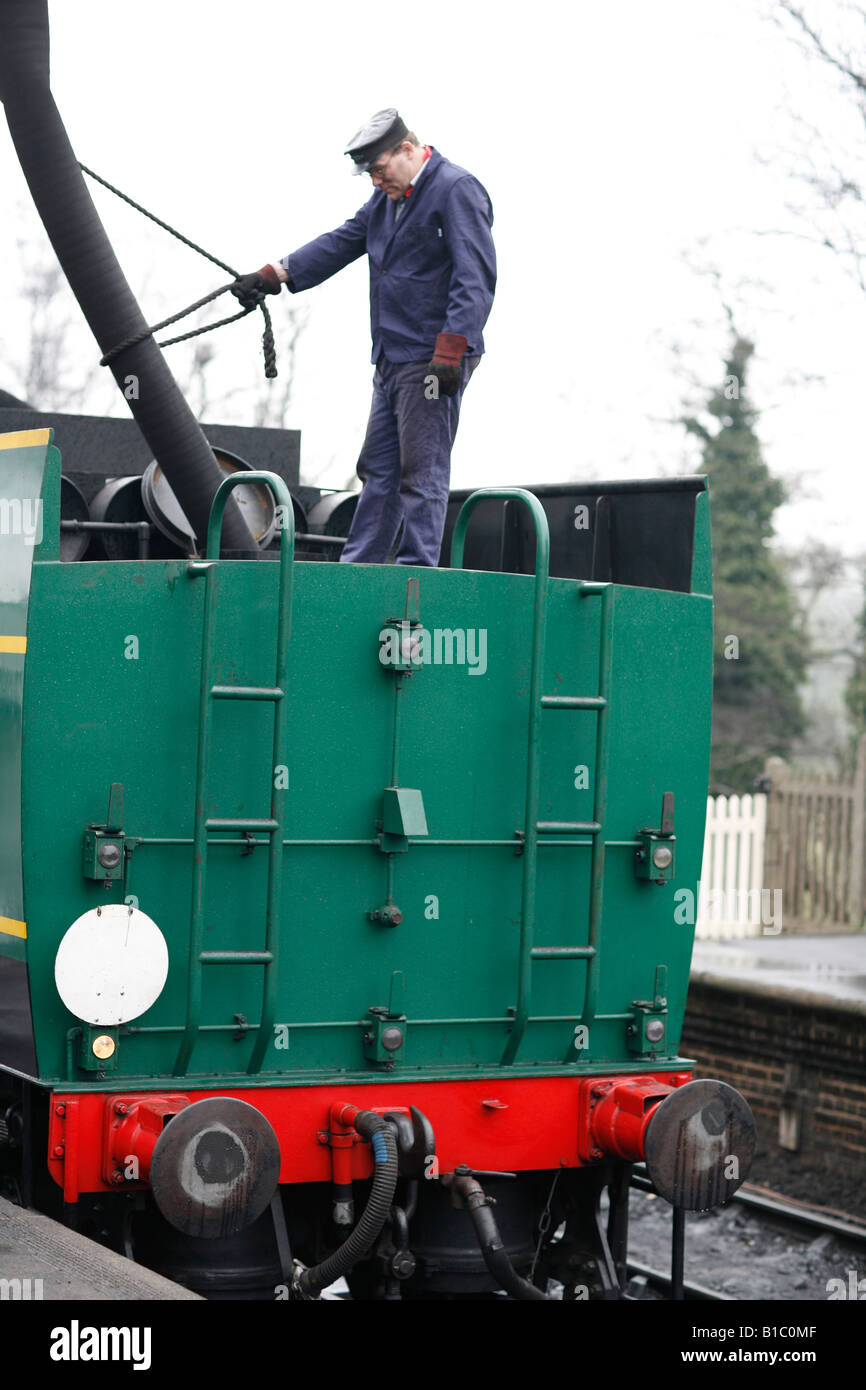 Filling steam engine with coal Stock Photo - Alamy