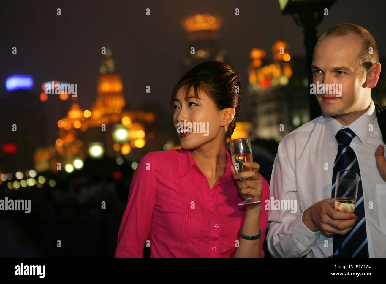 one businessmen and one businesswoman from different cultures smiling ...