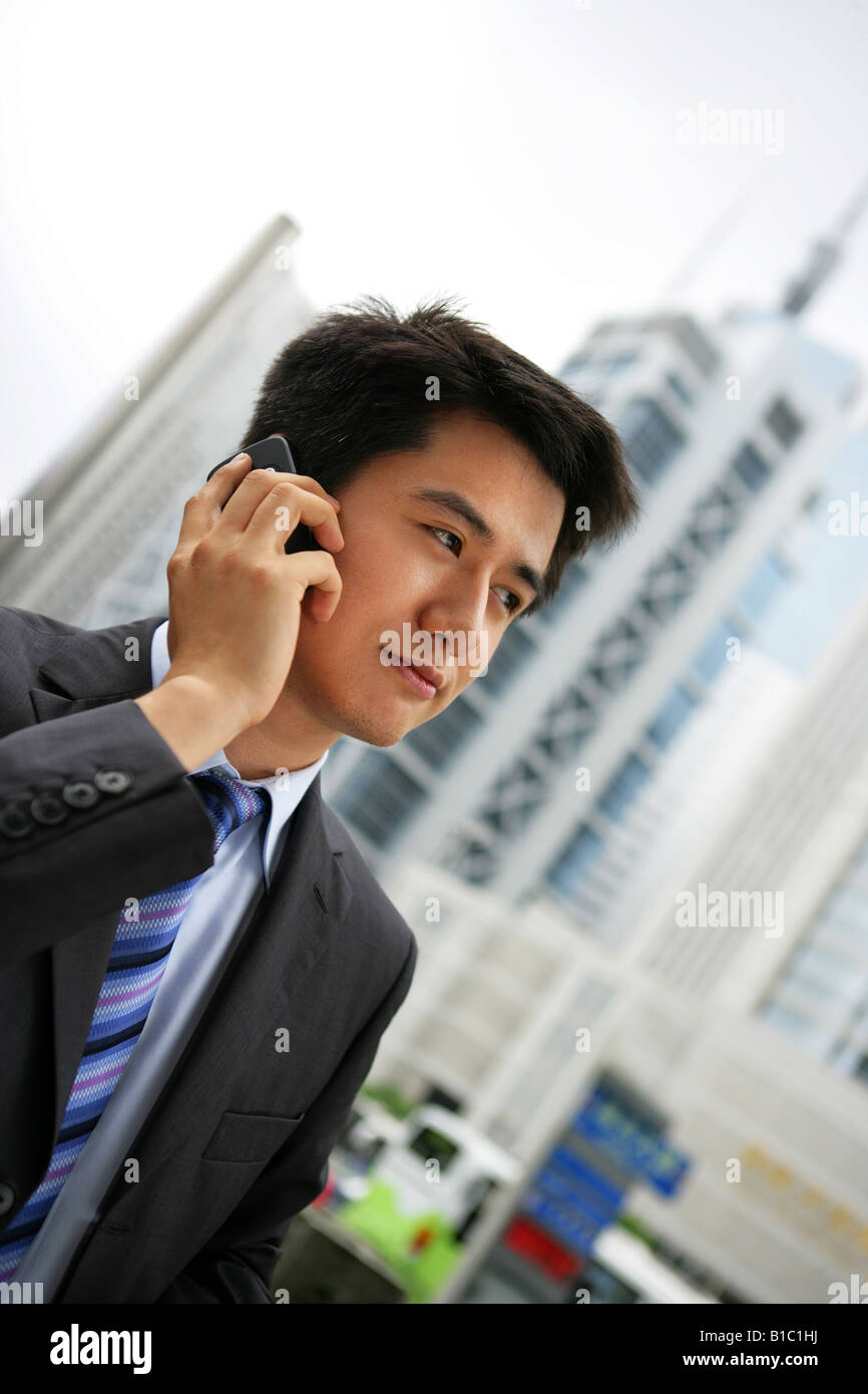 one businessman on the phone outside office buildings in Pudong ...