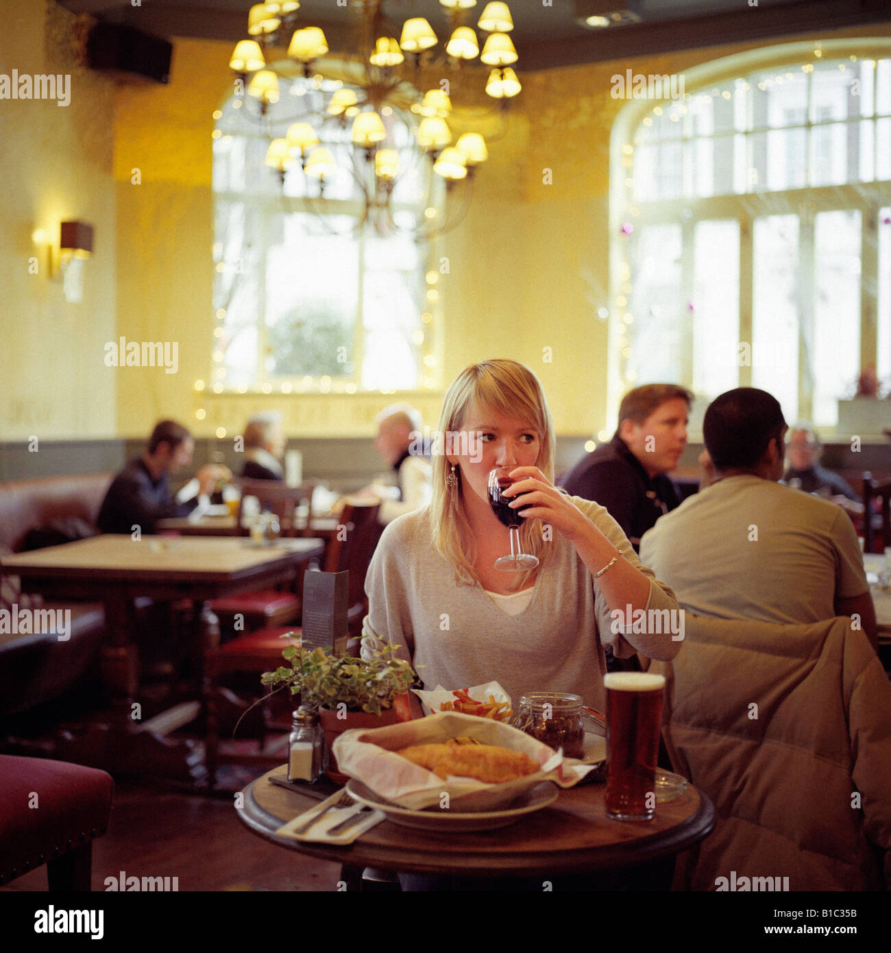 Pretty woman in bar drinking beer hi-res stock photography and images ...
