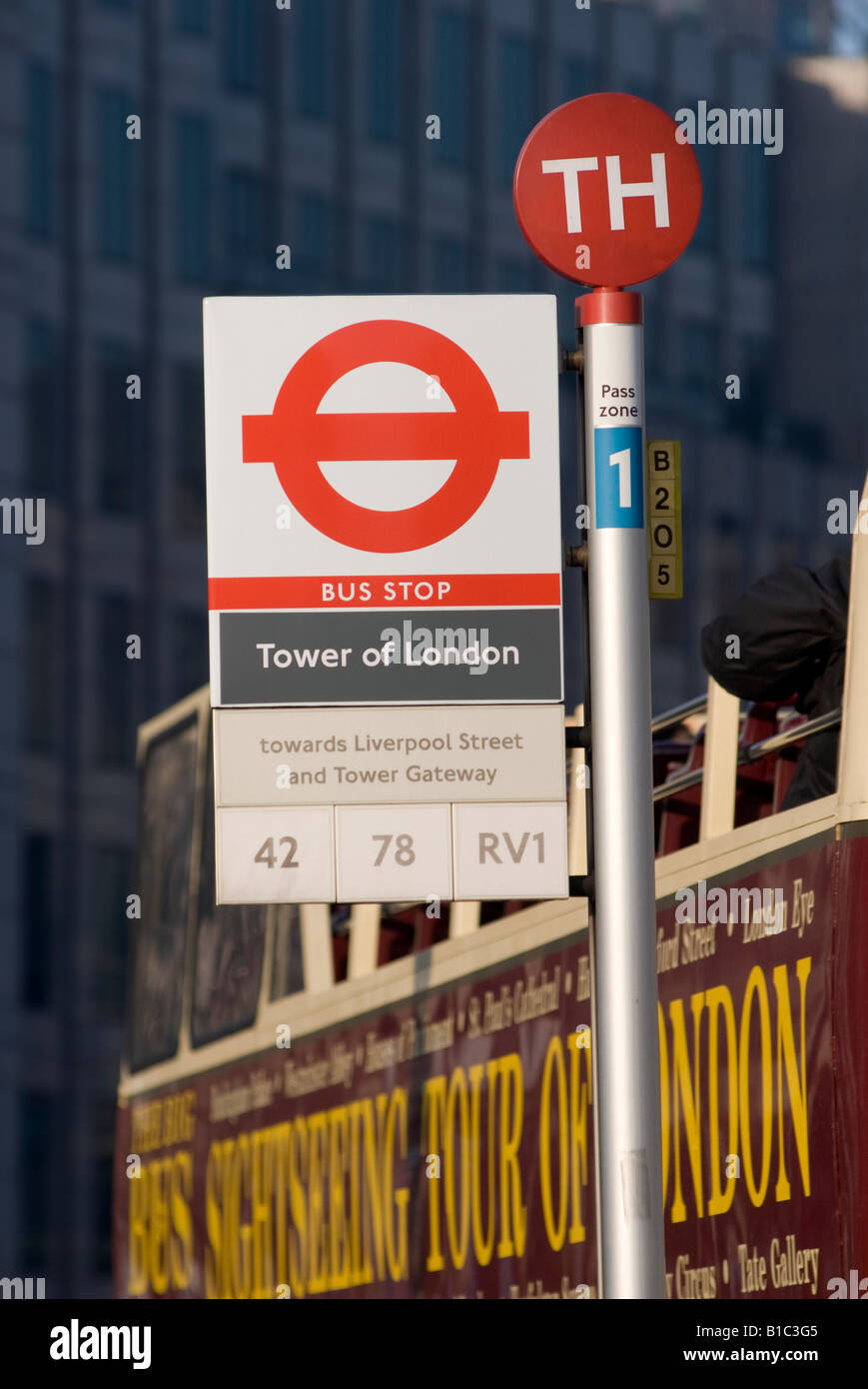 open top tourist bus at a London transport bus stop sign at the tower ...
