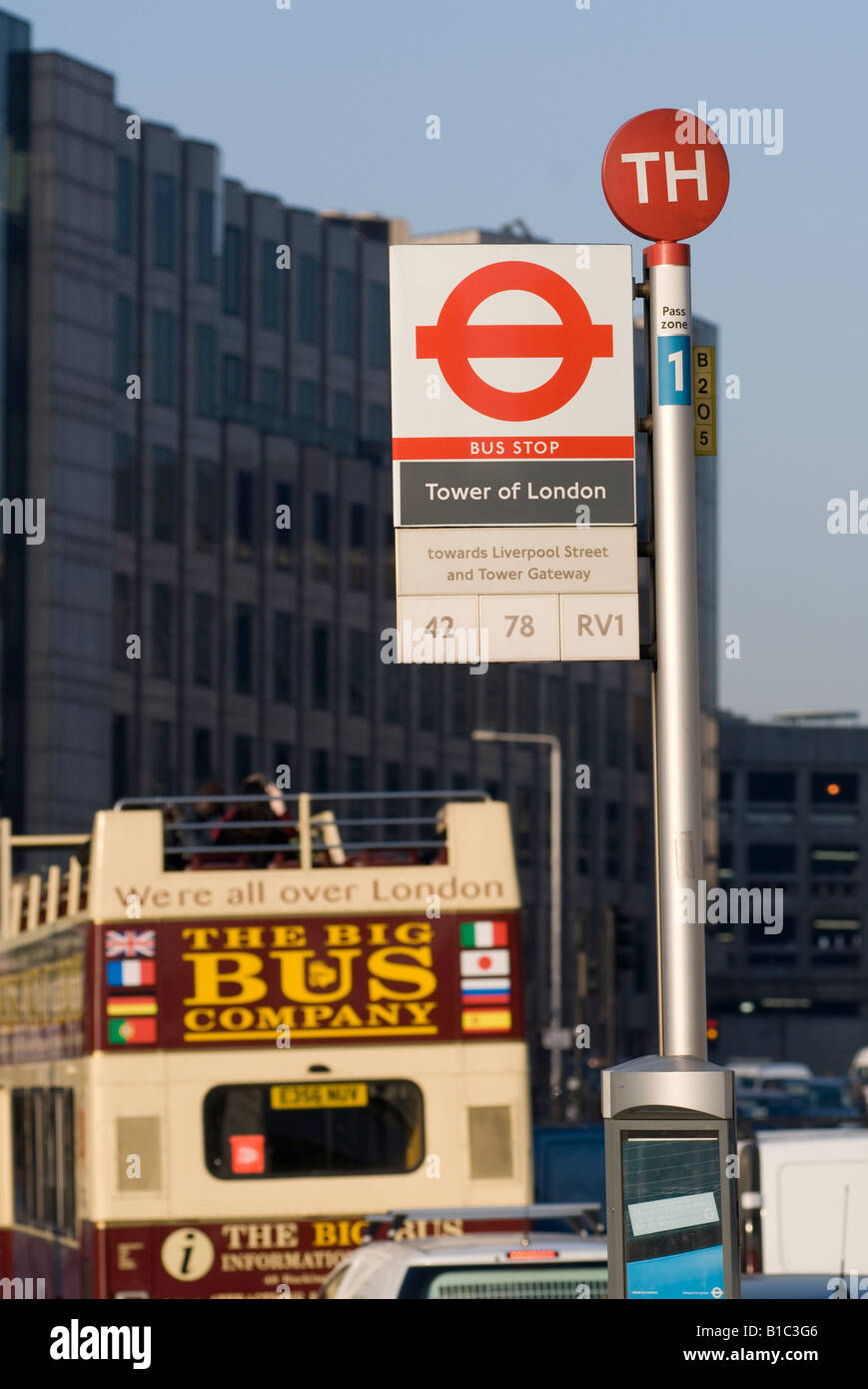 open top tourist bus at a London transport bus stop sign at the tower ...