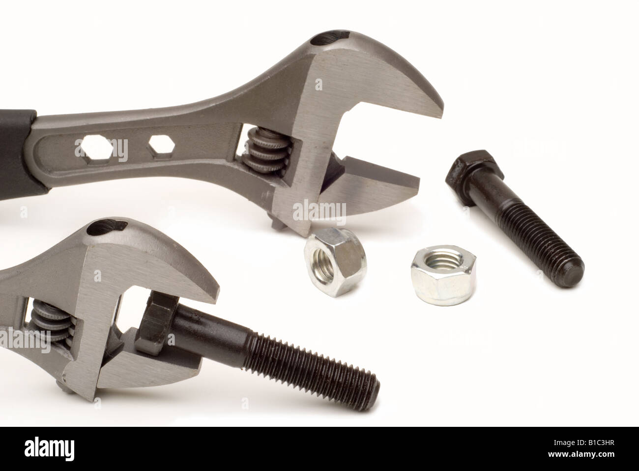 Close up of two wrench spanners with nuts and bolts Stock Photo - Alamy