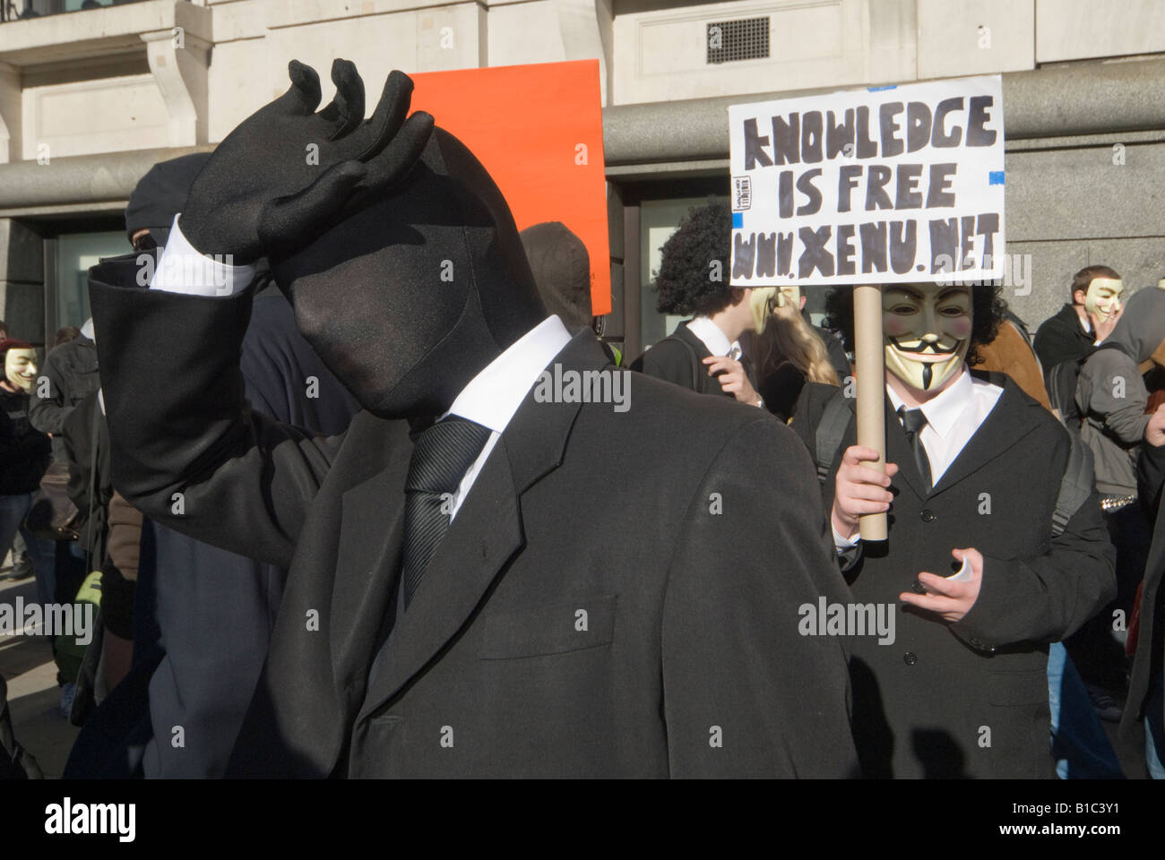 Man in black and other masked demonstrators at Anonymous protest ...
