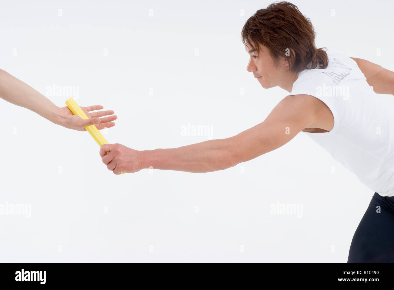 Young man giving relay baton Stock Photo - Alamy