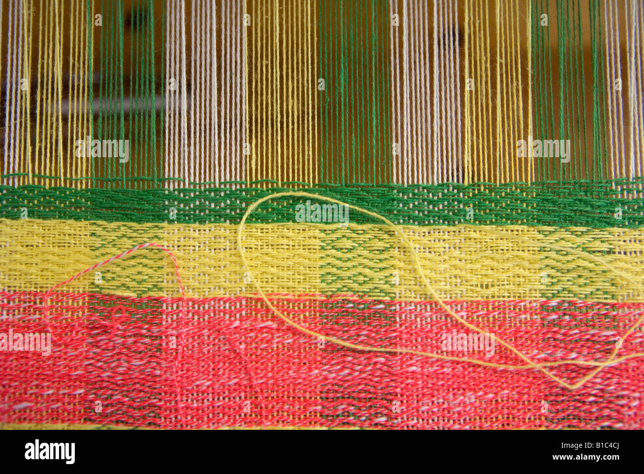 Material on a weaving loom Stock Photo - Alamy