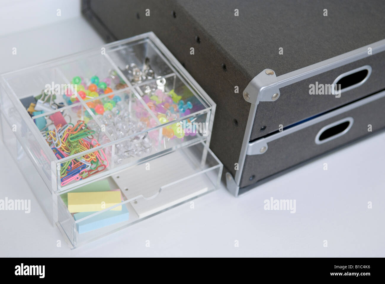 Clips and pushpins in plastic box Stock Photo - Alamy