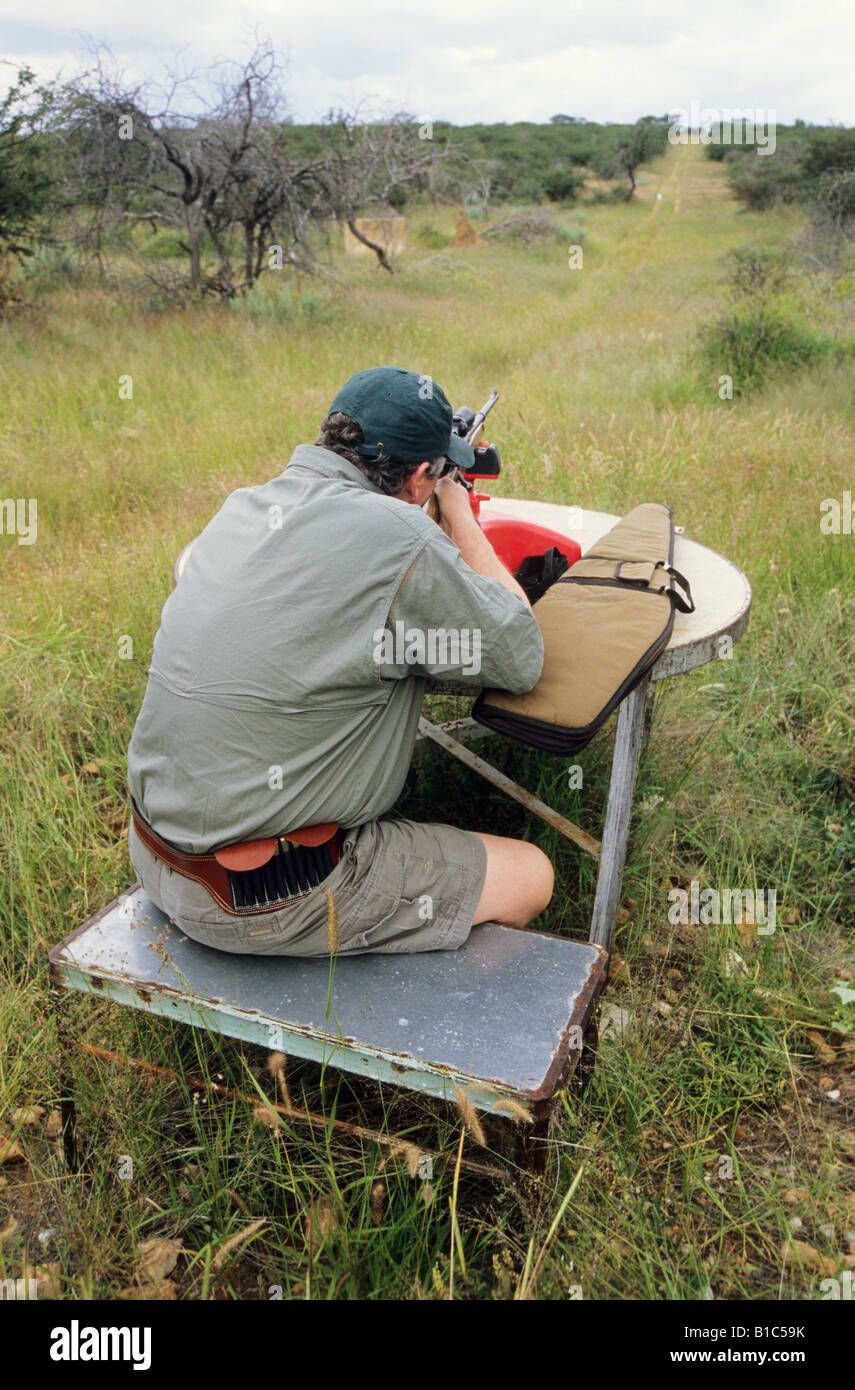 Okahanja, Namibia, safari, single adult man sitting, hunter aiming ...