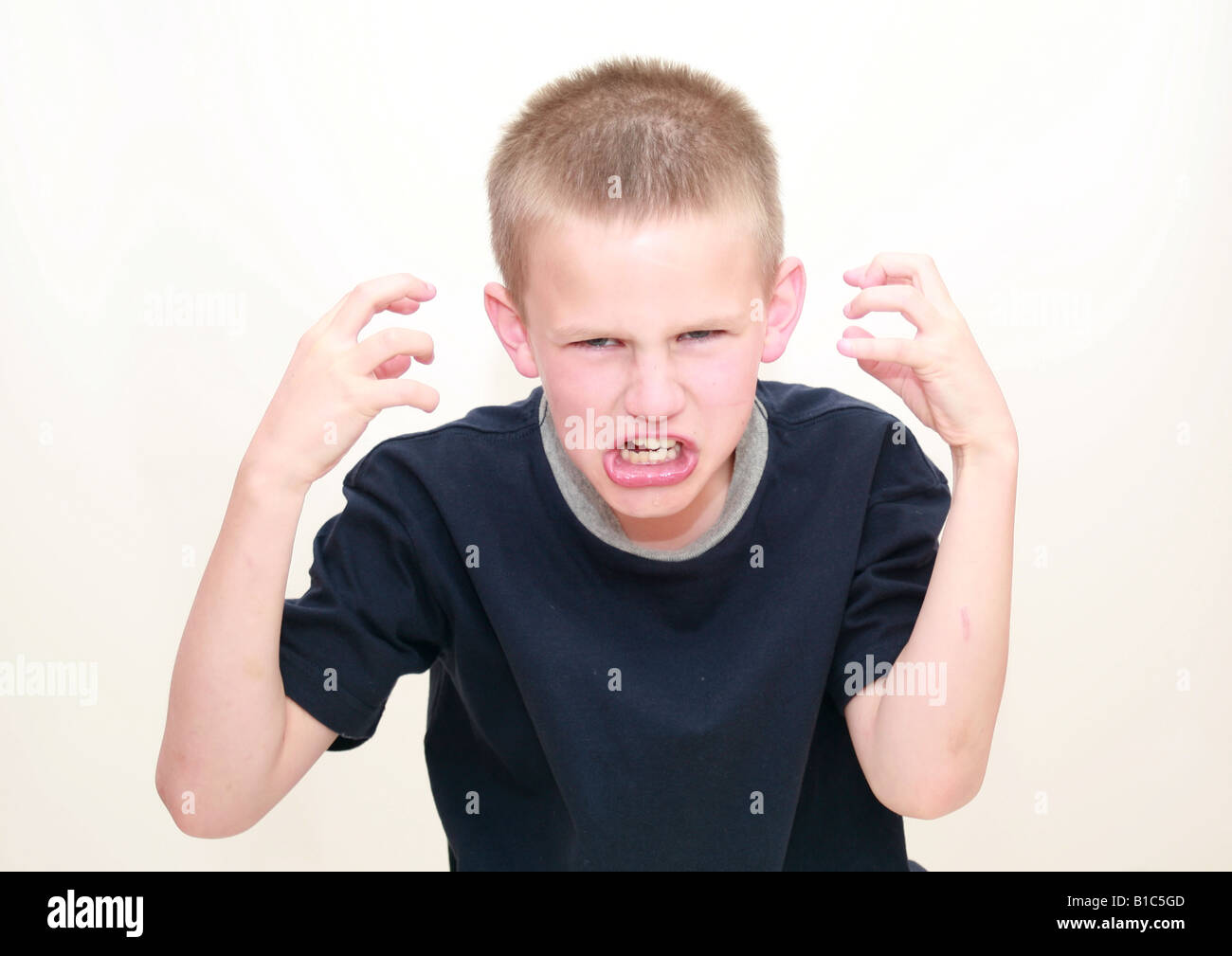 Boy in studio with angry expression and hand gestures Stock Photo - Alamy