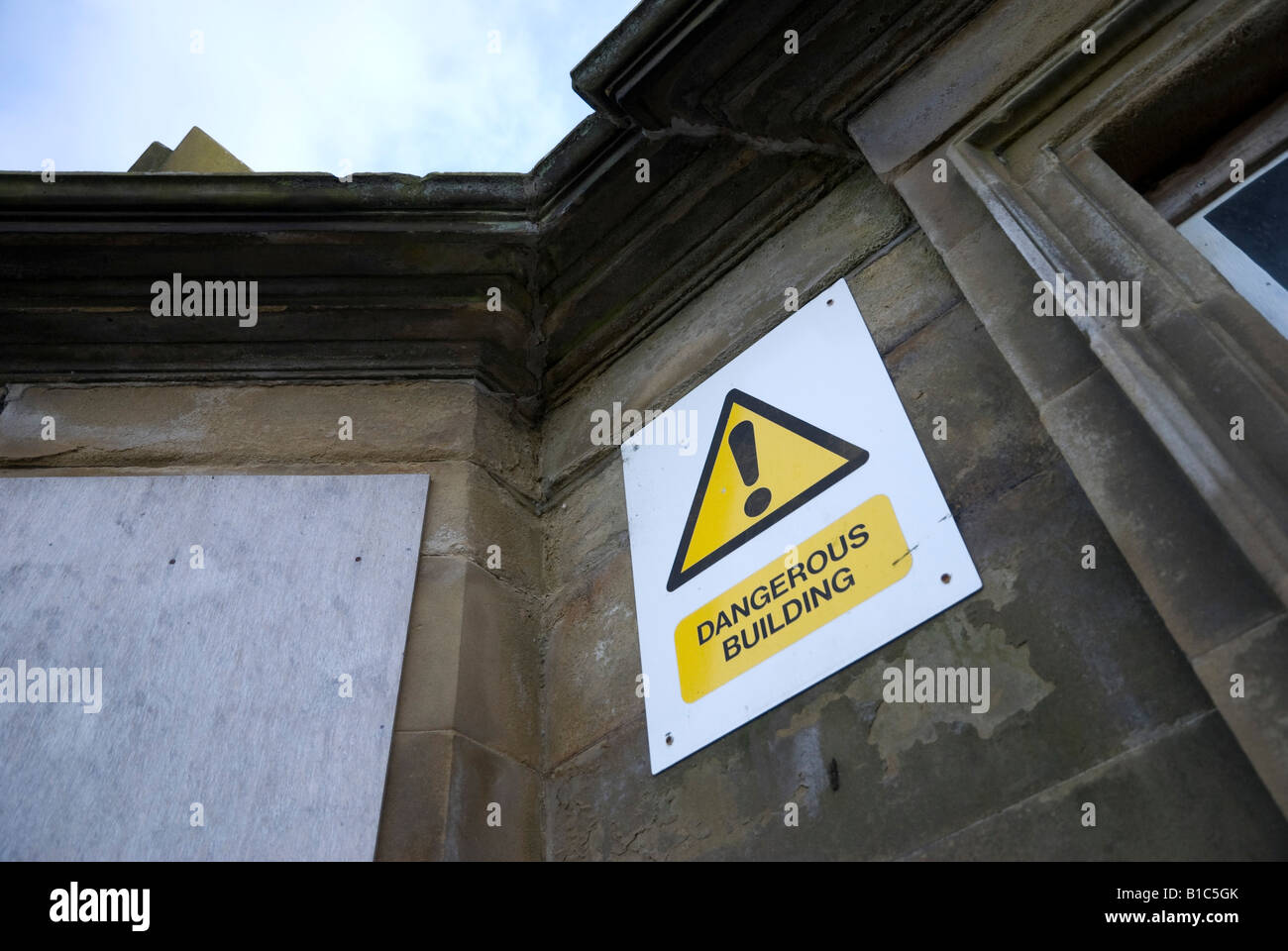 Dangerous building warning sign Stock Photo - Alamy