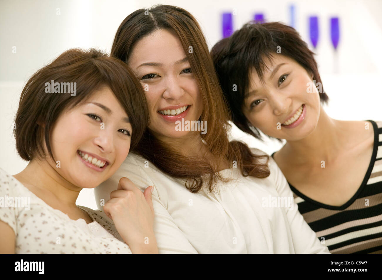 Portrait of three young women smiling Stock Photo - Alamy