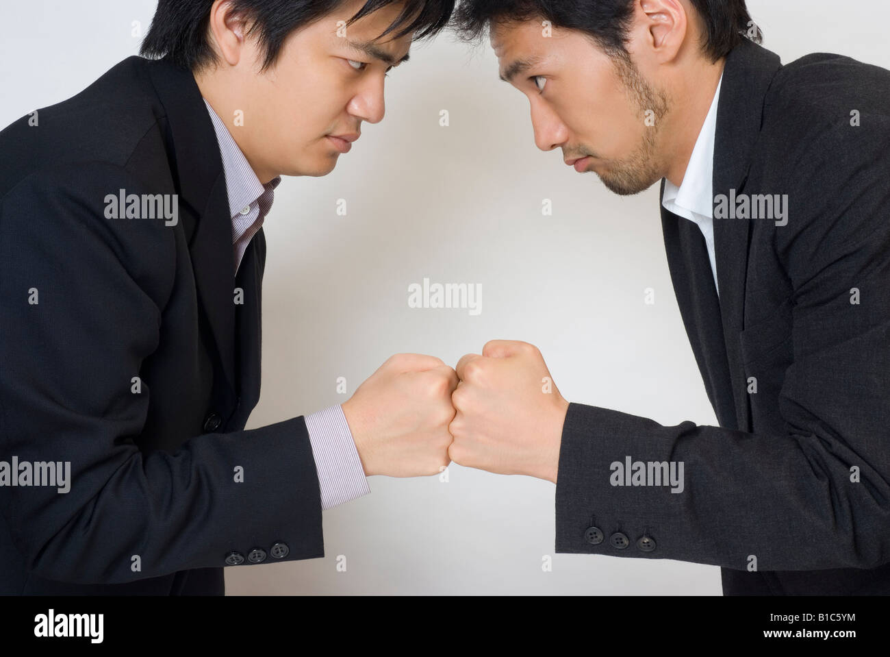 Two businessmen glaring each other Stock Photo - Alamy