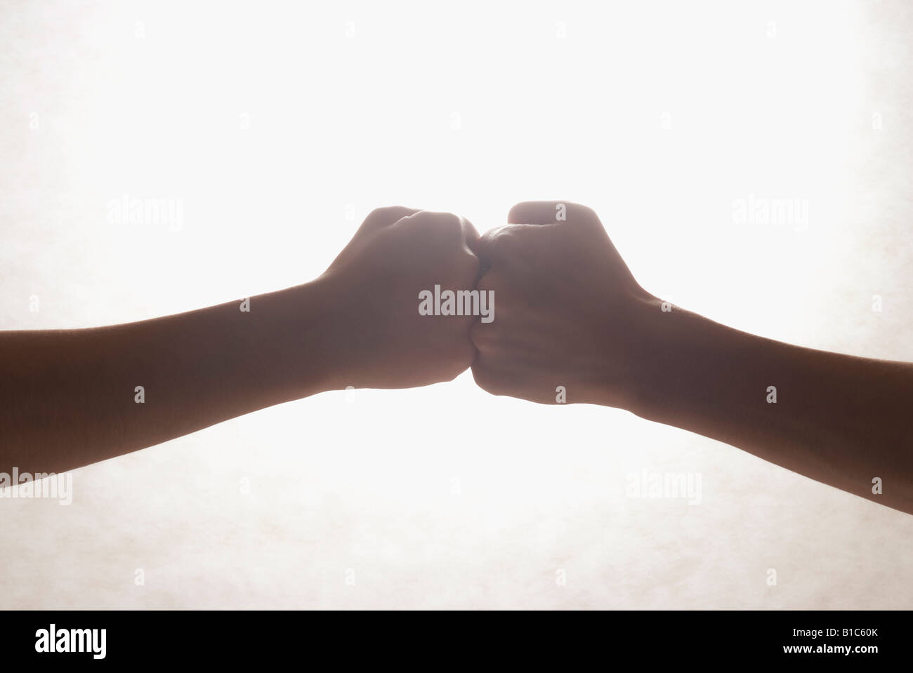 Two hands touching knuckles together Stock Photo - Alamy