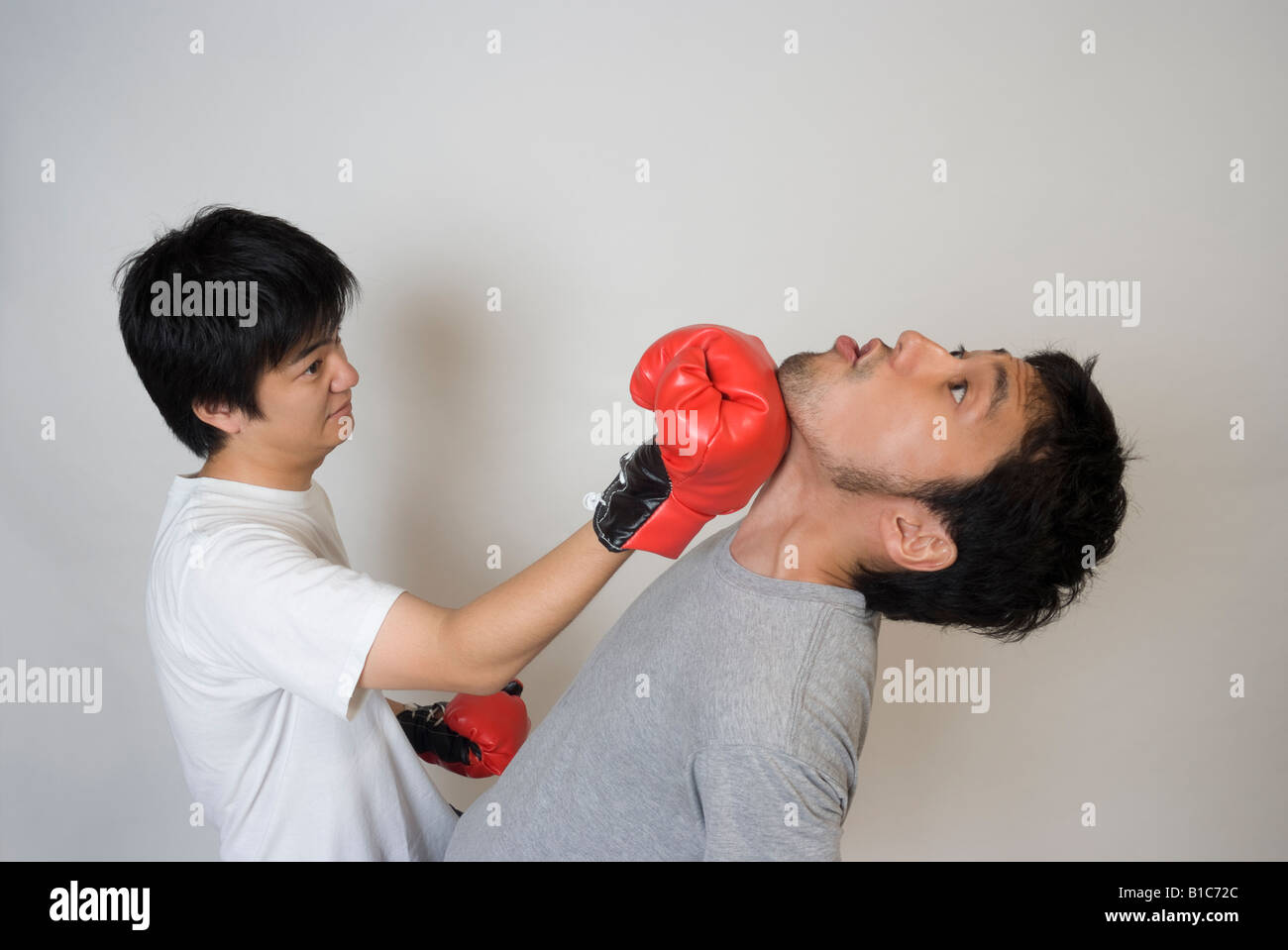 Two young men fighting Stock Photo - Alamy