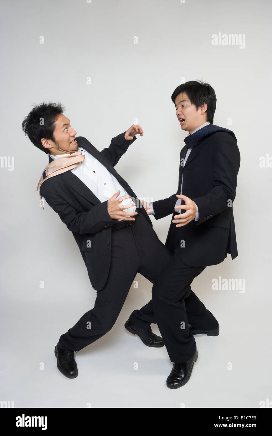Two businessmen fighting Stock Photo - Alamy