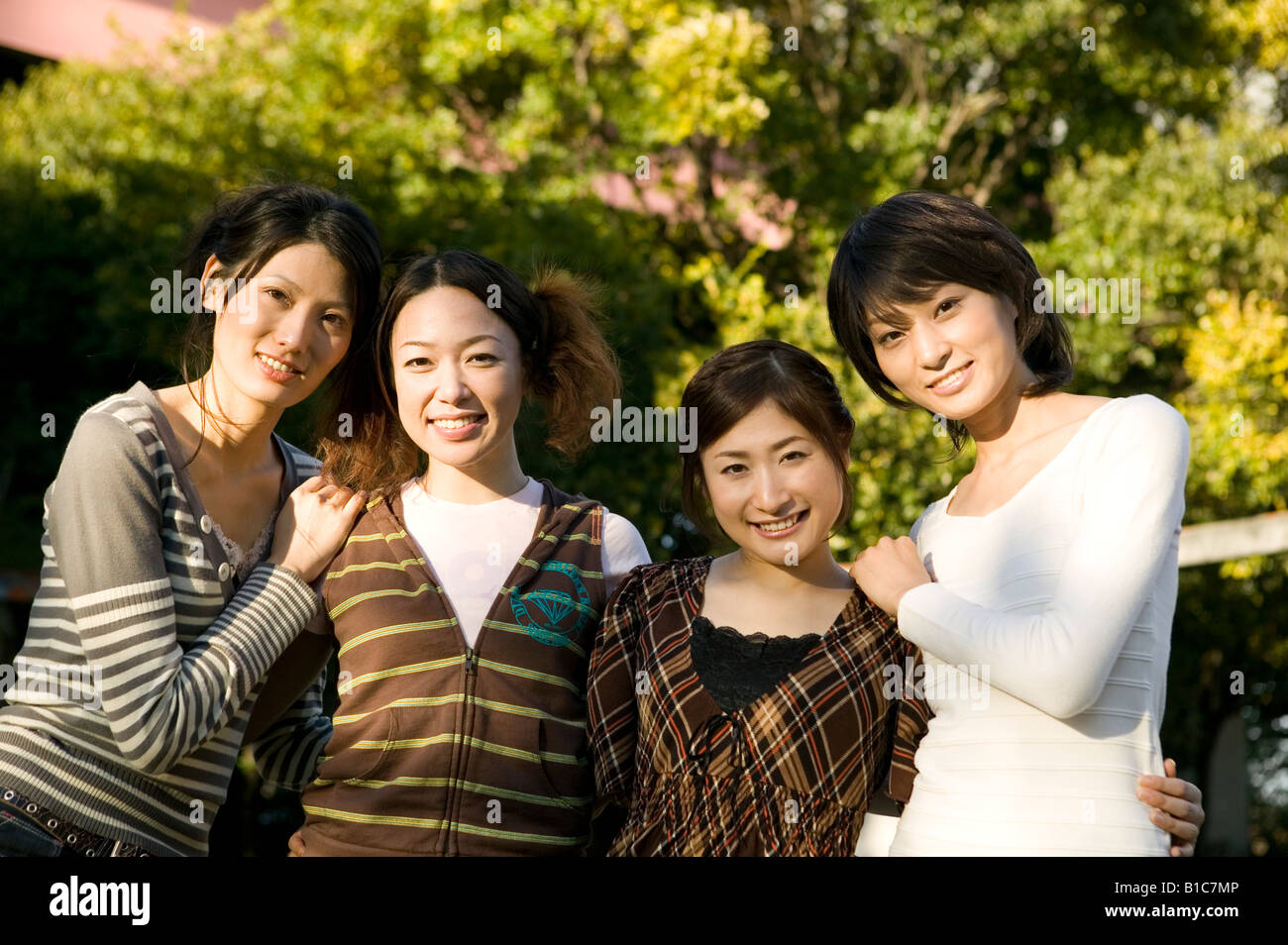 Portrait of four women smiling Stock Photo - Alamy