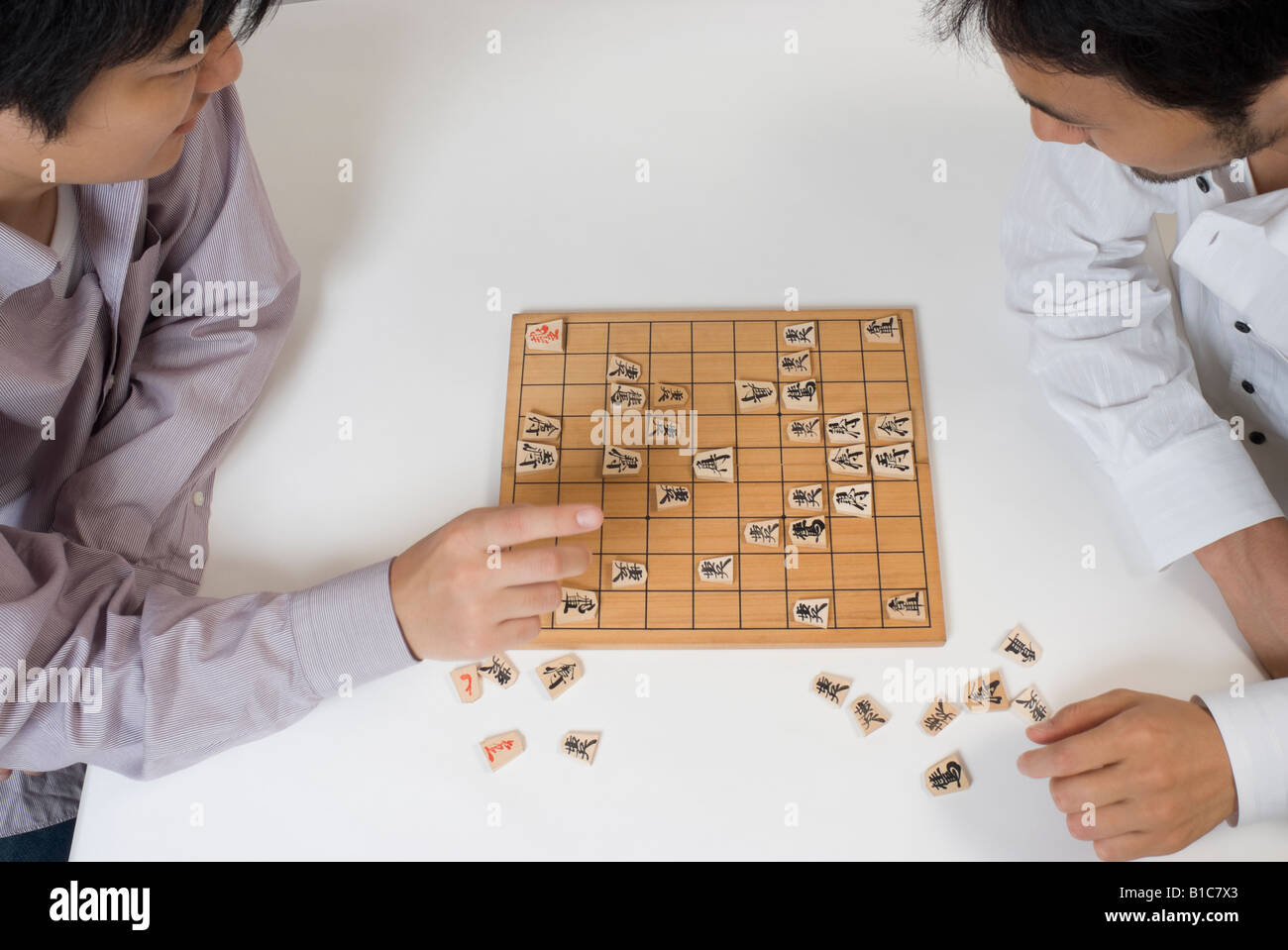 Two young men playing Japanese chess Stock Photo - Alamy